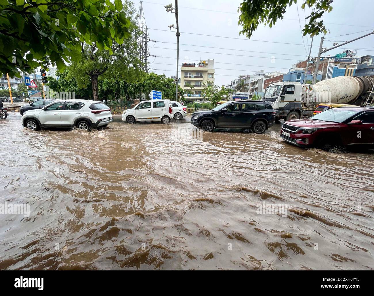 GURUGRAM, INDIA - JULY 9: Vehicles wade through a waterlogged stretch after the rain at sector ...