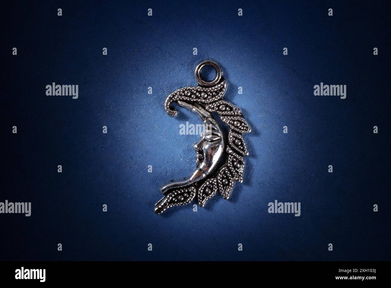 The Moon talisman, a symbol of the Wiccan Goddess on a dark blue ...