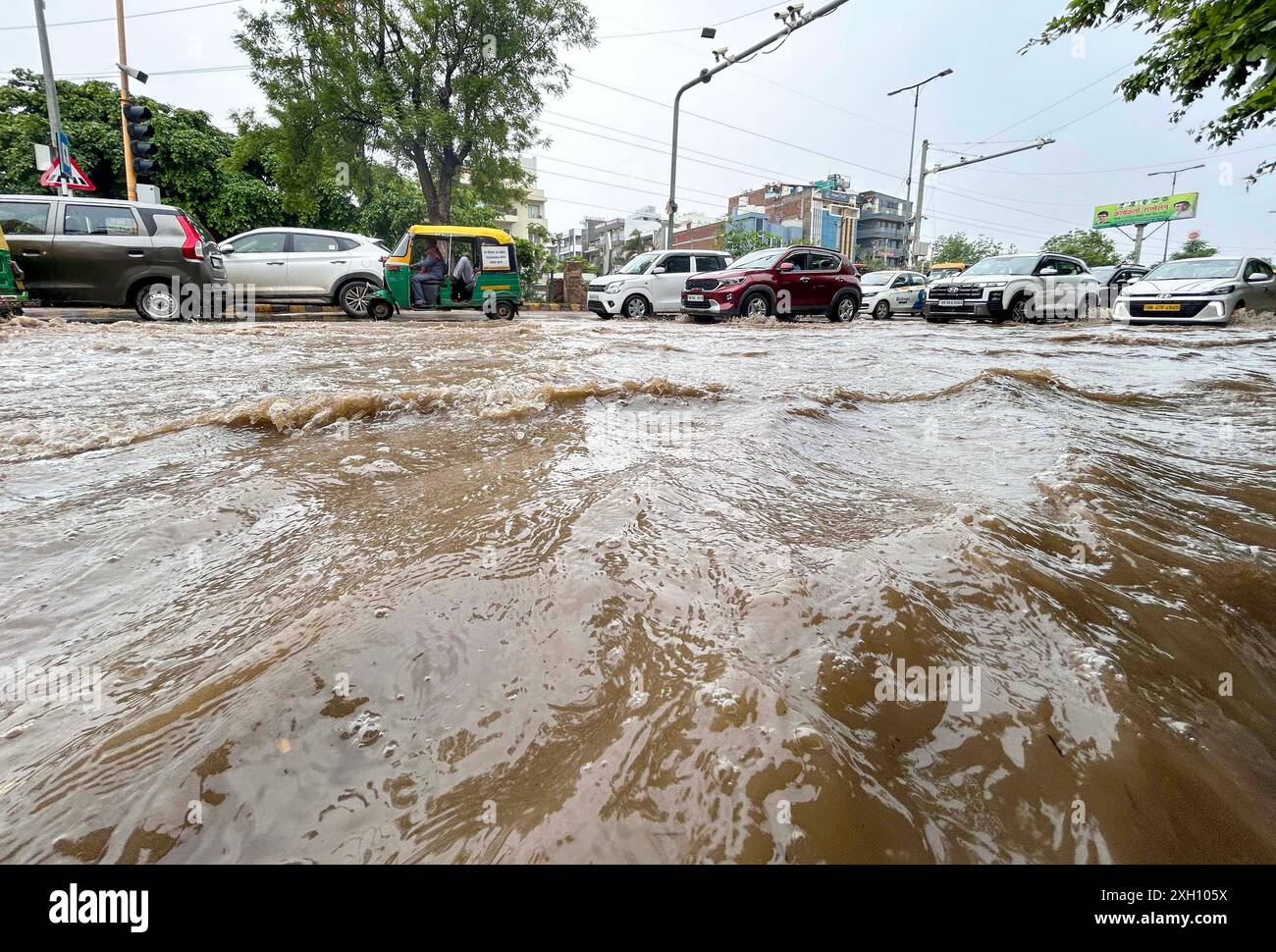 GURUGRAM, INDIA - JULY 9: Vehicles wade through a waterlogged stretch after the rain at sector ...
