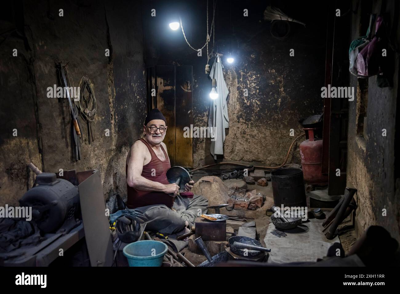 A Kashmiri silversmith is seen working in his workshop in downtown ...