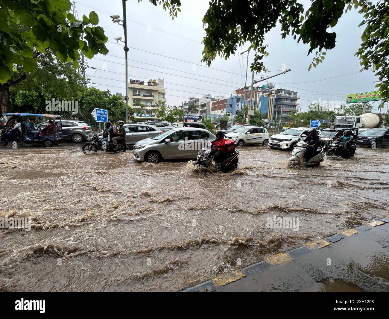 Vehicles leaving on waterlogged road hi-res stock photography and ...