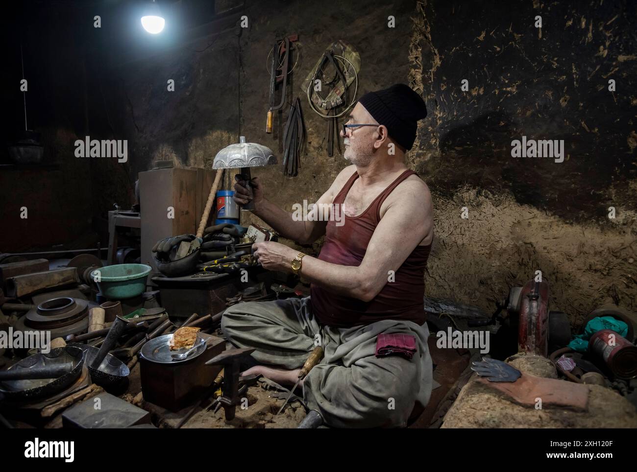 A Kashmiri silversmith is seen working in his workshop in downtown ...