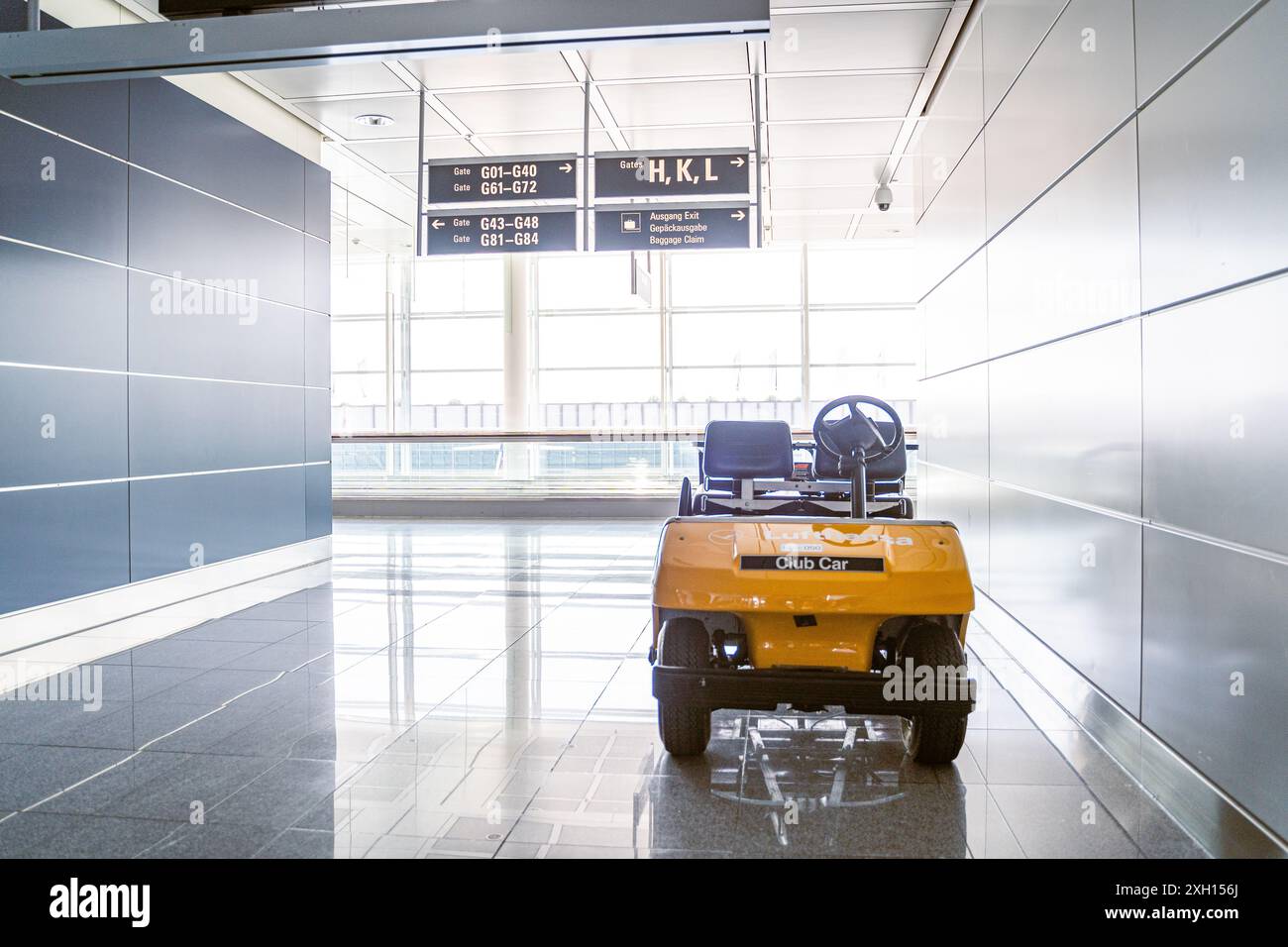 A modern terminal hallway with an airport transportation cart for ...