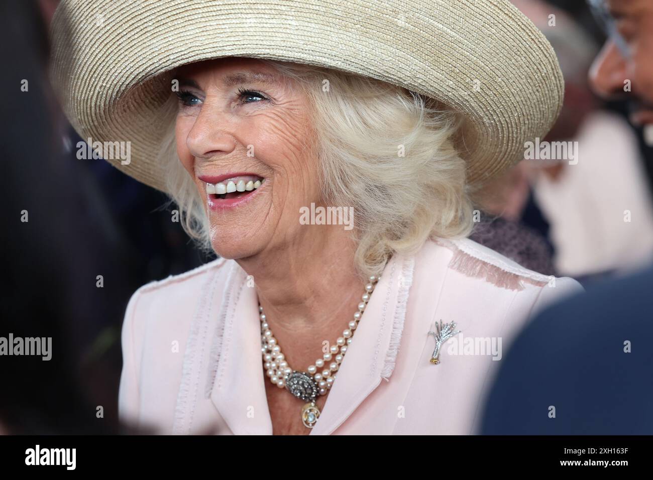 Queen Camilla smiles during a visit to the Senedd in Cardiff to mark ...
