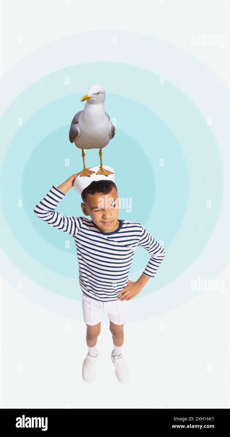 Boy in a sailor outfit, with a seagull perched on his hat, looking ...