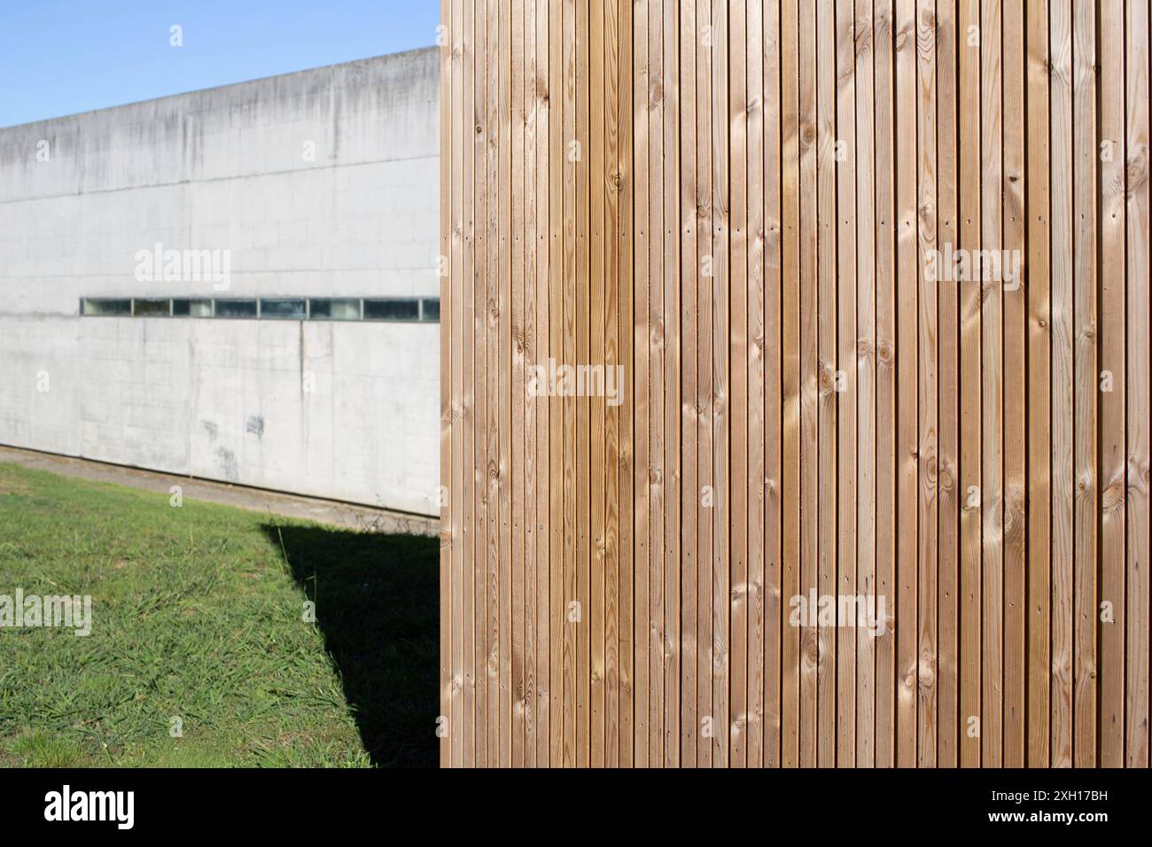 Modern building with Wood paneling detail and concrete facade ...