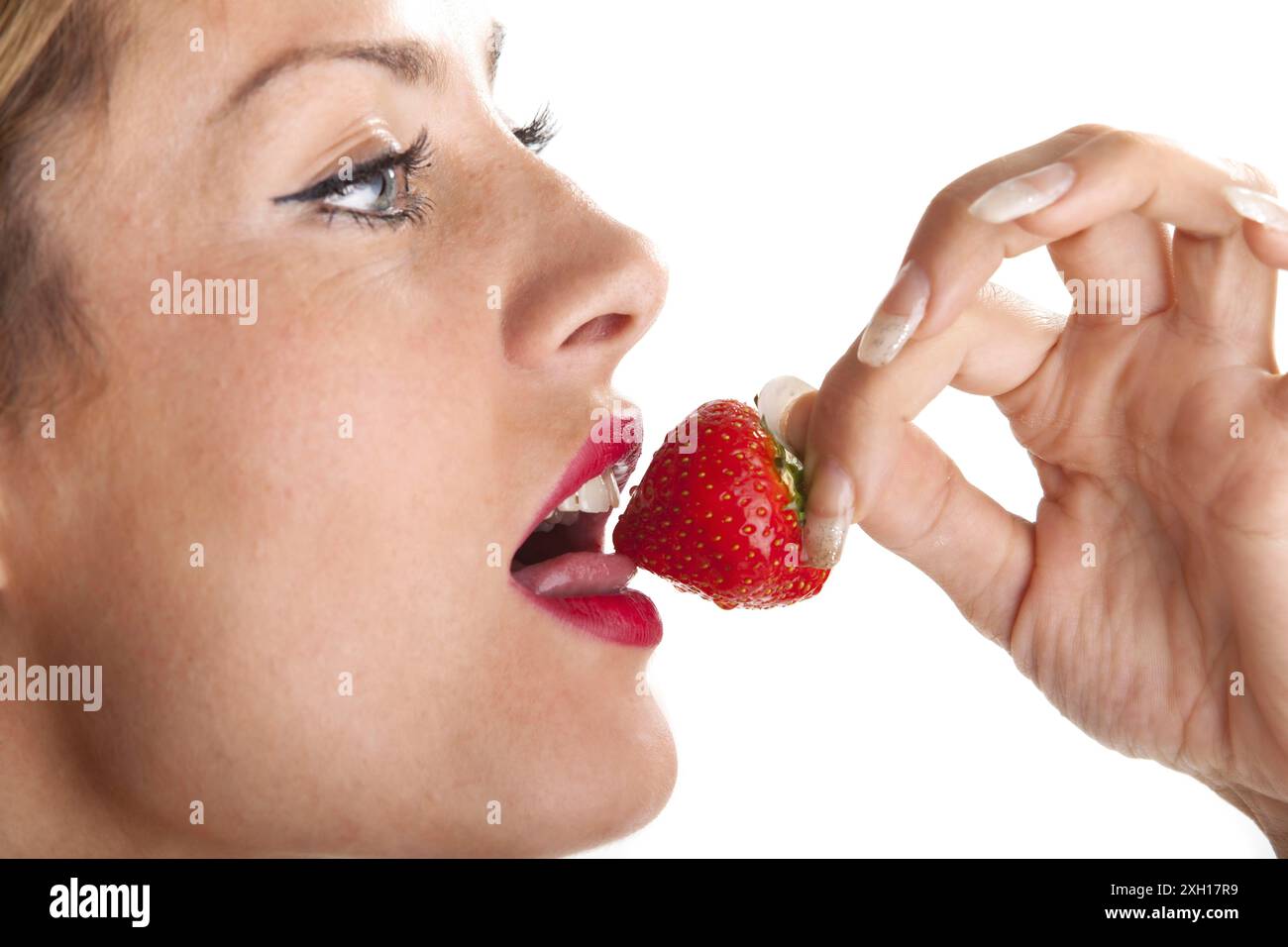 Woman eating a strawberry hi-res stock photography and images - Alamy
