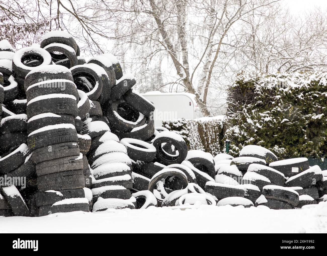 Old car tyres on a heap in the snow Stock Photo - Alamy