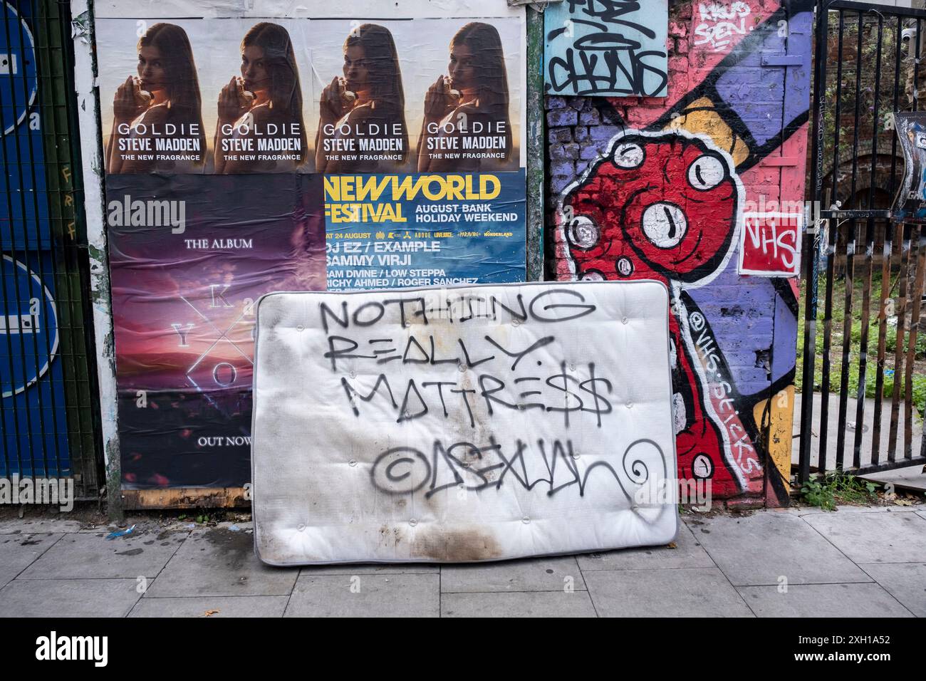 Discarded matress turned poetic artwork with graffiti reading Nothing ...