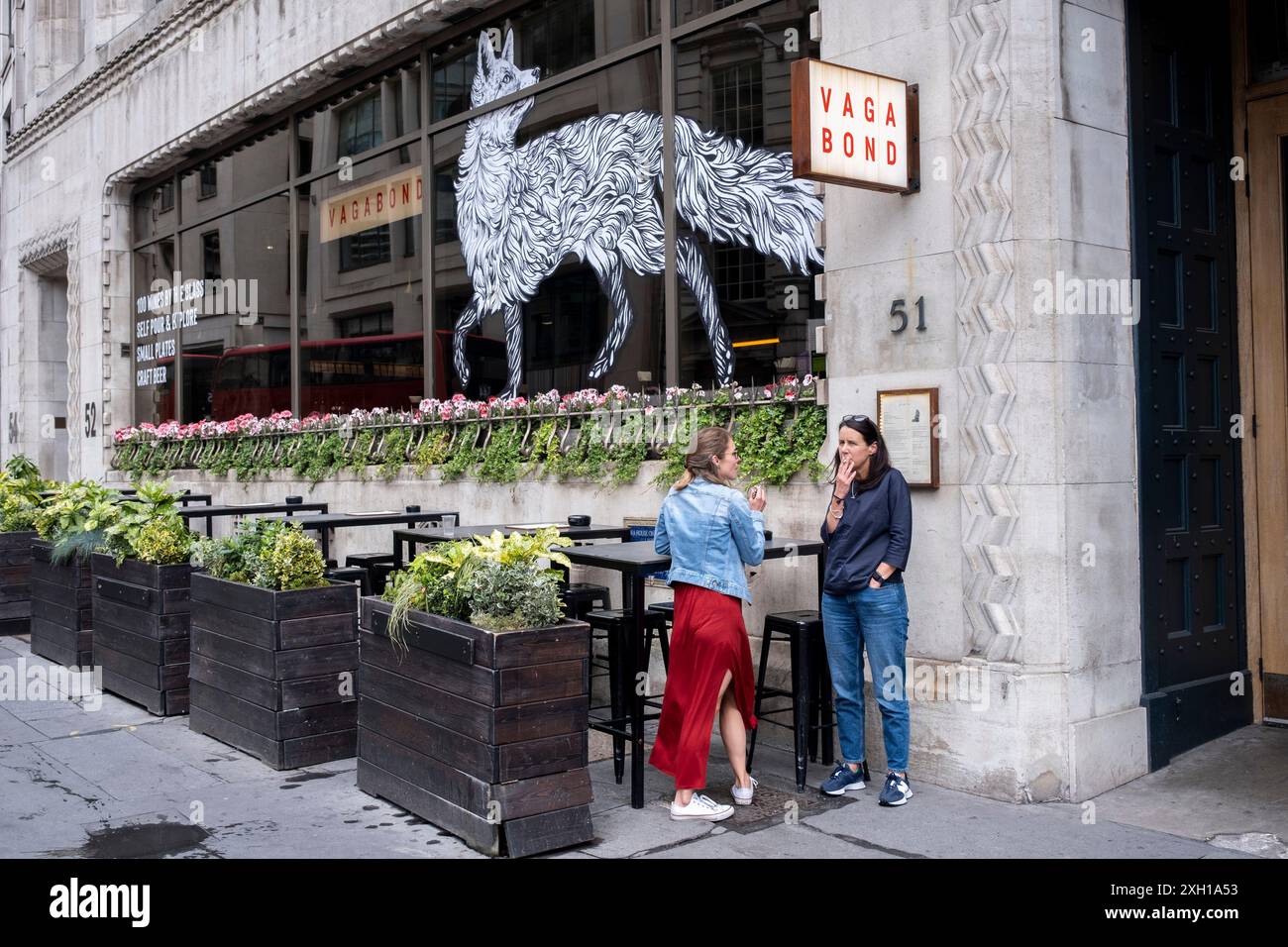 Fox motif in the window of the Vagabond wine store and bar as two ...