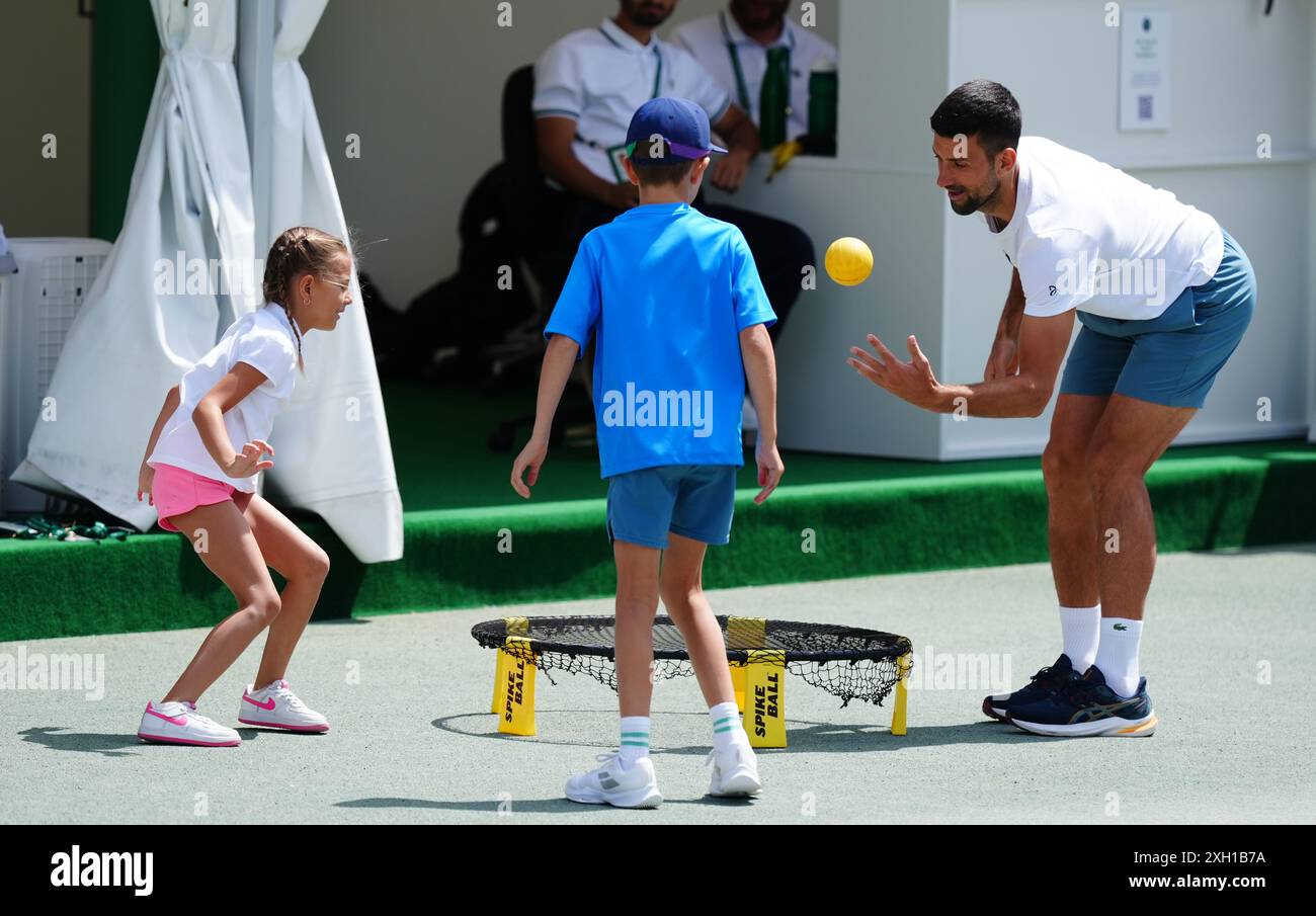 Novak Djokovic with his children before his match on day eleven of the ...