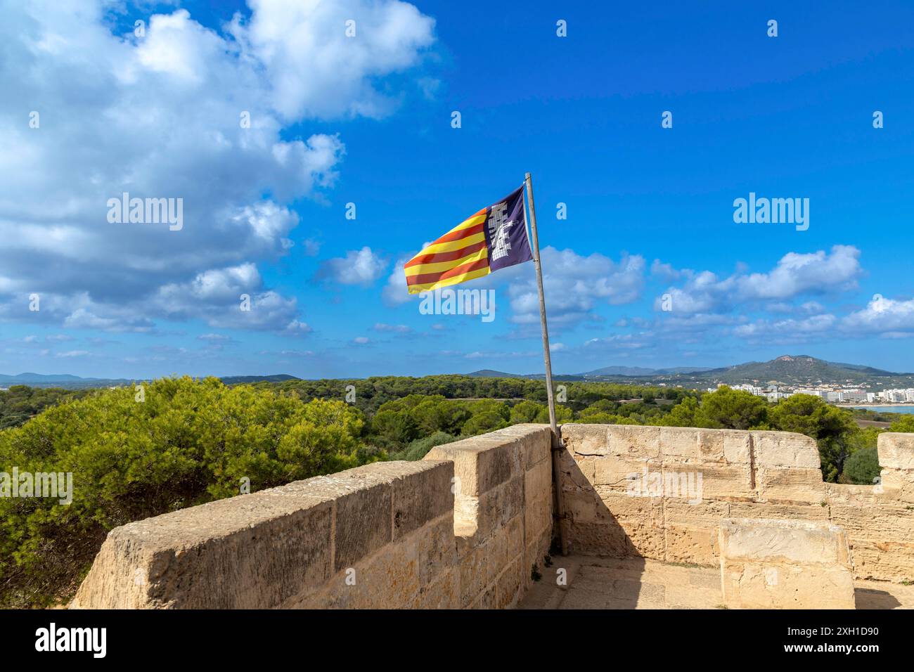 Flag of Majorca on an old defence defence tower in the Punta de n'Amer ...