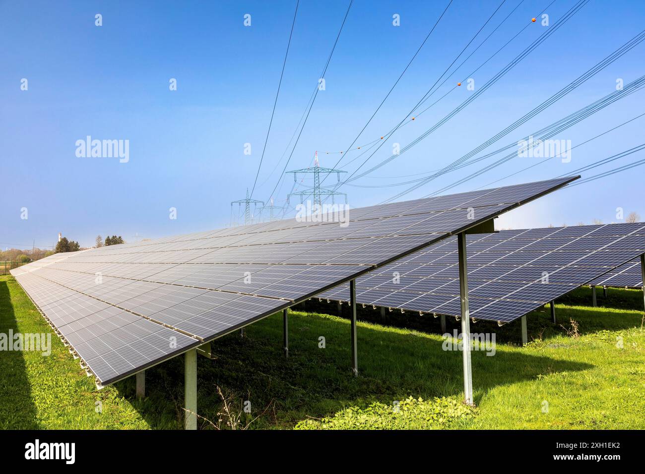 Solar park with high-voltage pylons Stock Photo - Alamy
