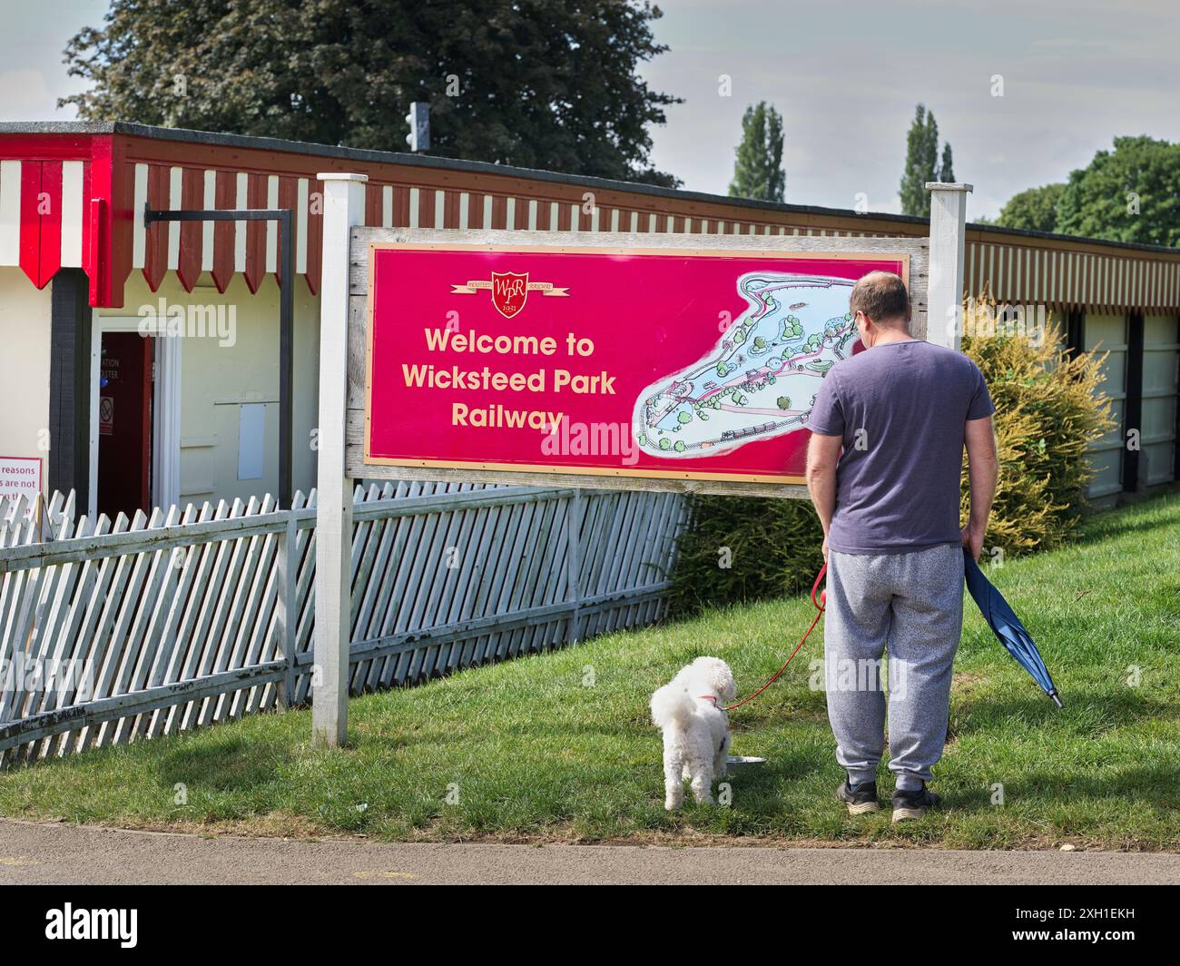 One man and his daog by railway station at Wicksteed Park, Kettering ...