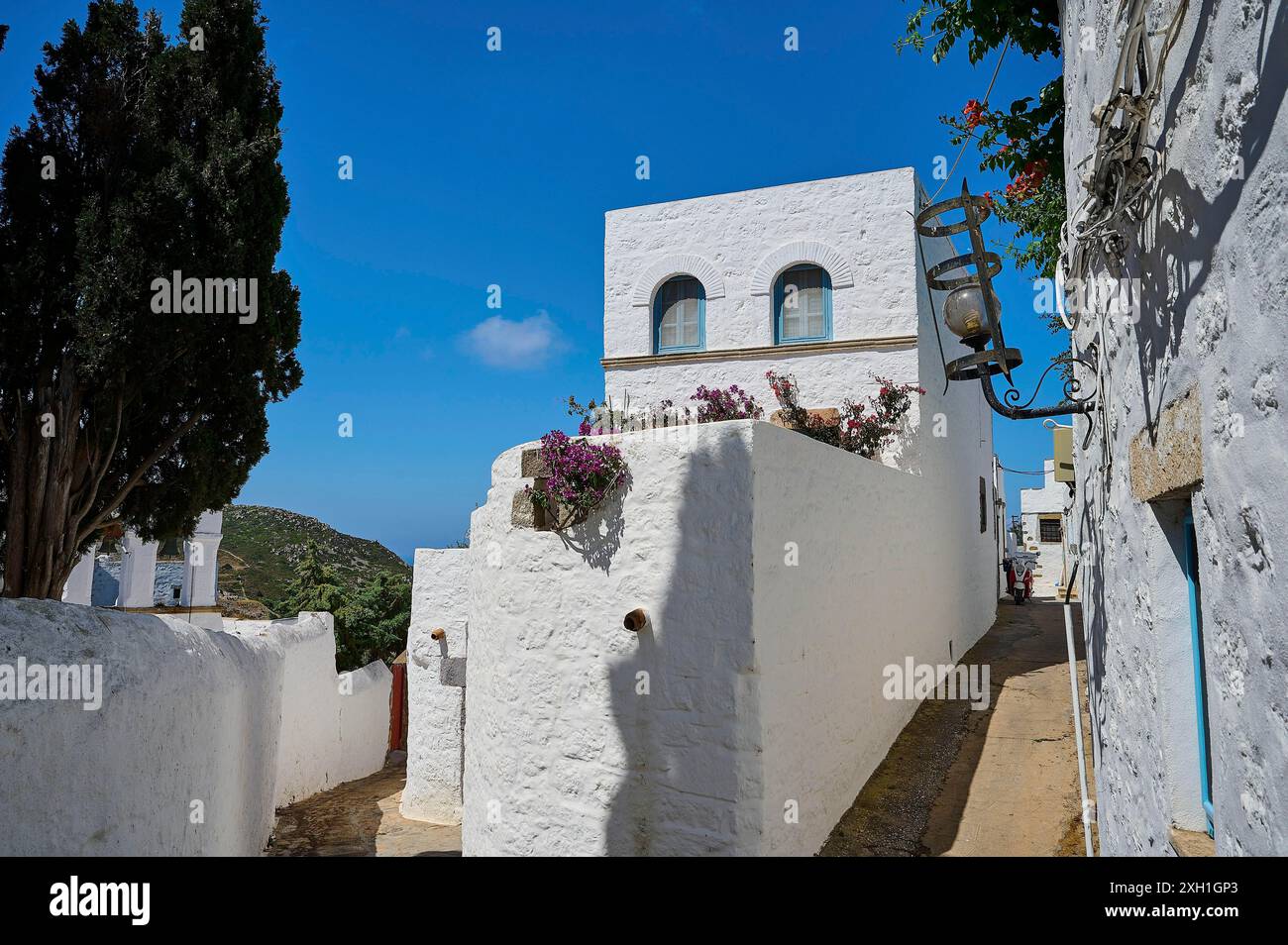 White, Mediterranean houses with blue sky, flowers on the balcony ...