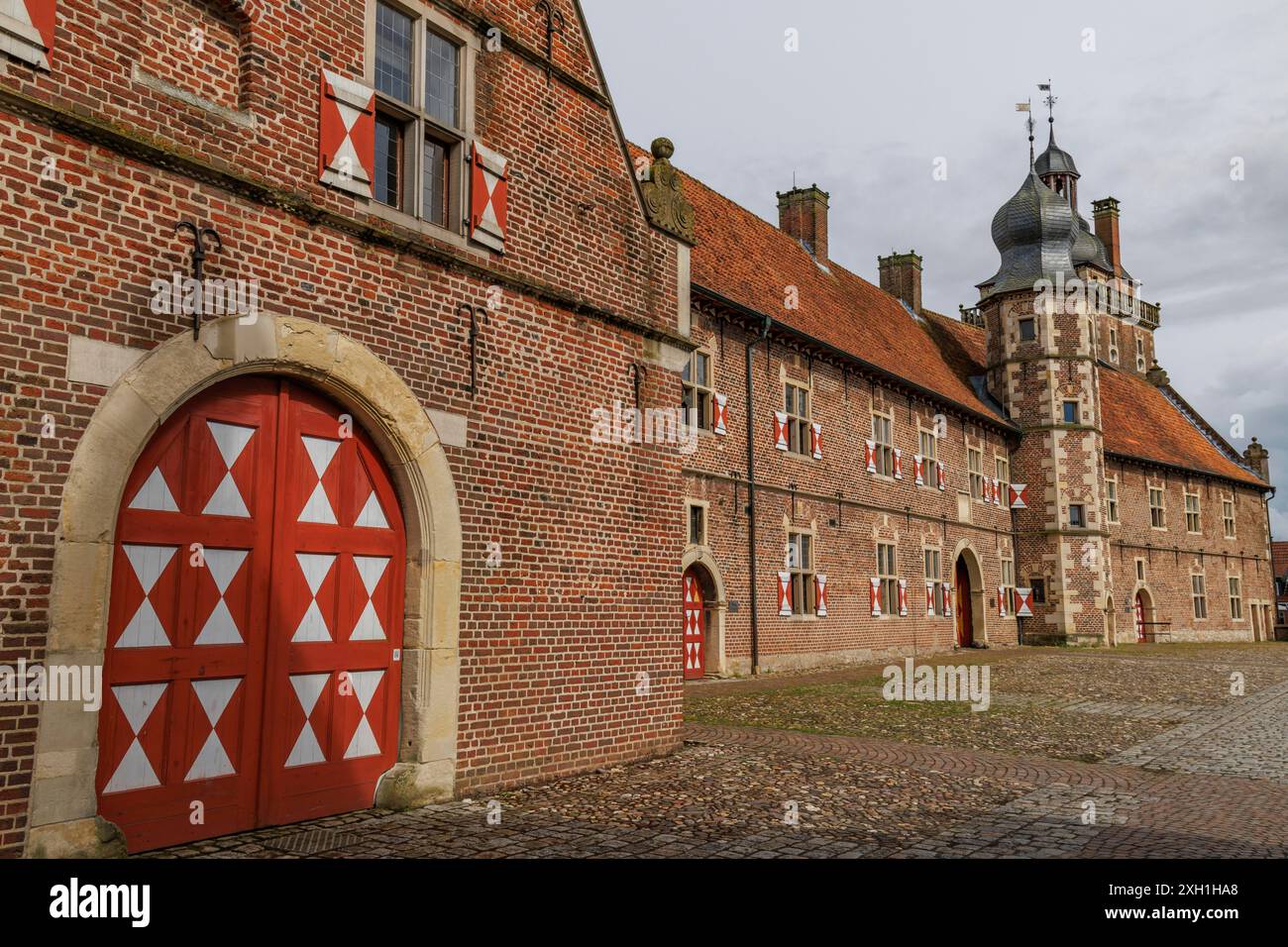 Historic brick building with archway, colourfully painted doors and ...