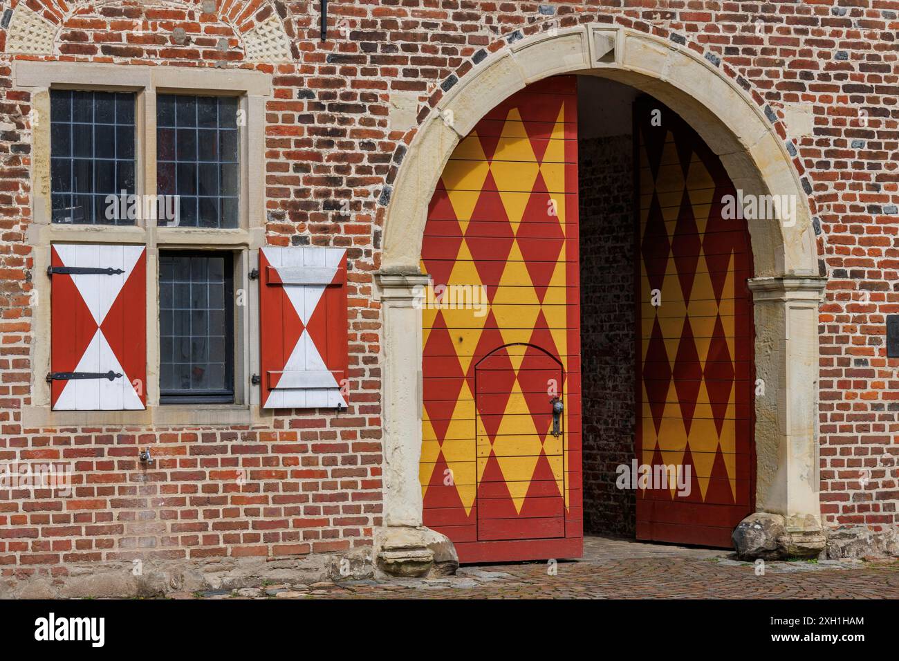 Brick building with colourful doors and windows in half-timbered style ...