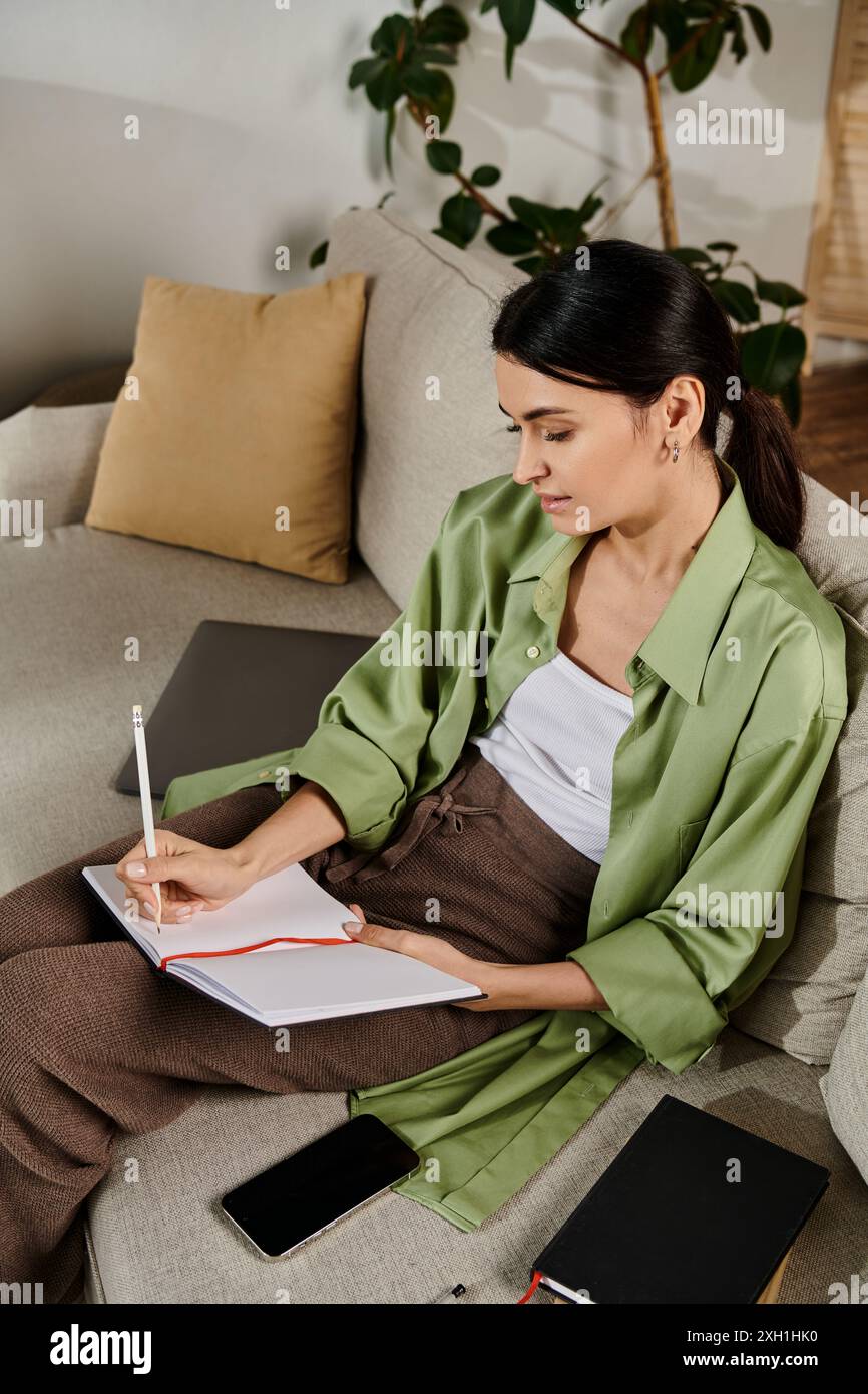 Woman journaling on couch hi-res stock photography and images - Alamy