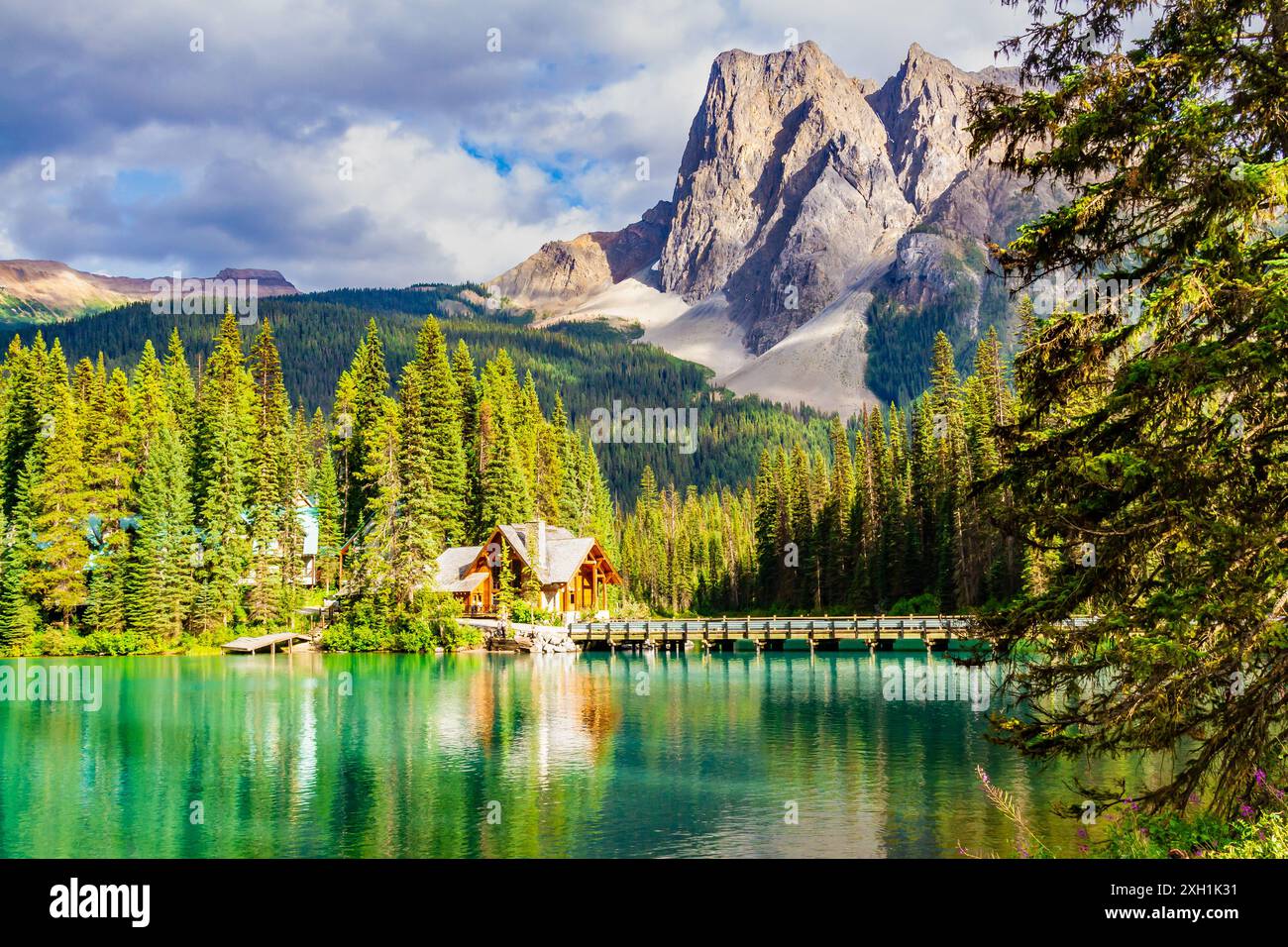 Landscape of the rocky mountains . Wooden bridge and building on Emerald Lake. Yoho National ...