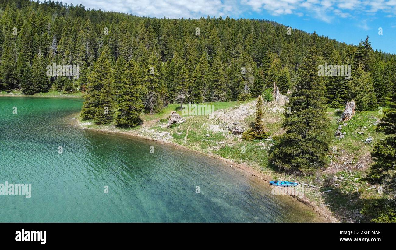 Aerial view of a kayak on the beautiful teal blue waters of Crystal ...