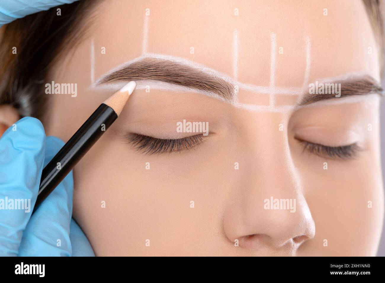 Permanent make-up for eyebrows of beautiful woman with thick brows in ...