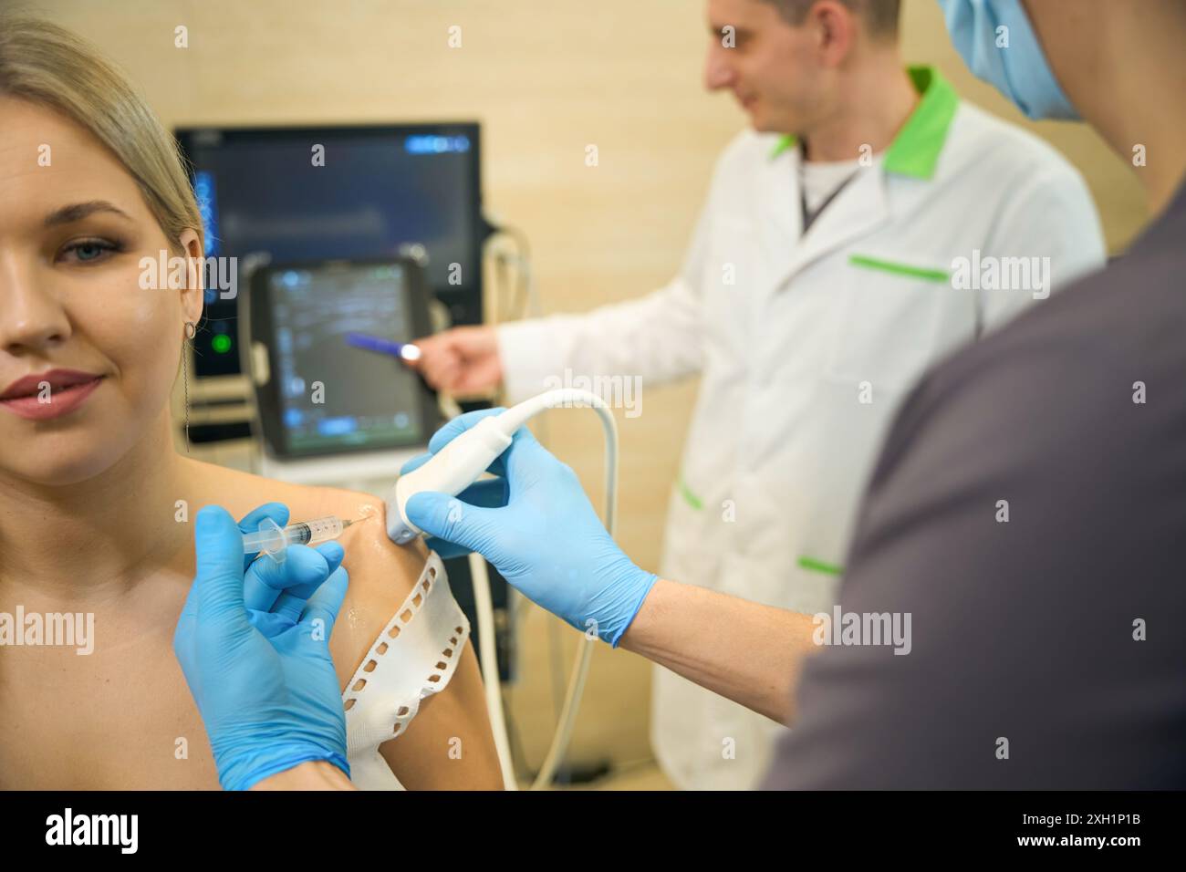 Healthcare professional giving ultrasound-guided shoulder injection to ...