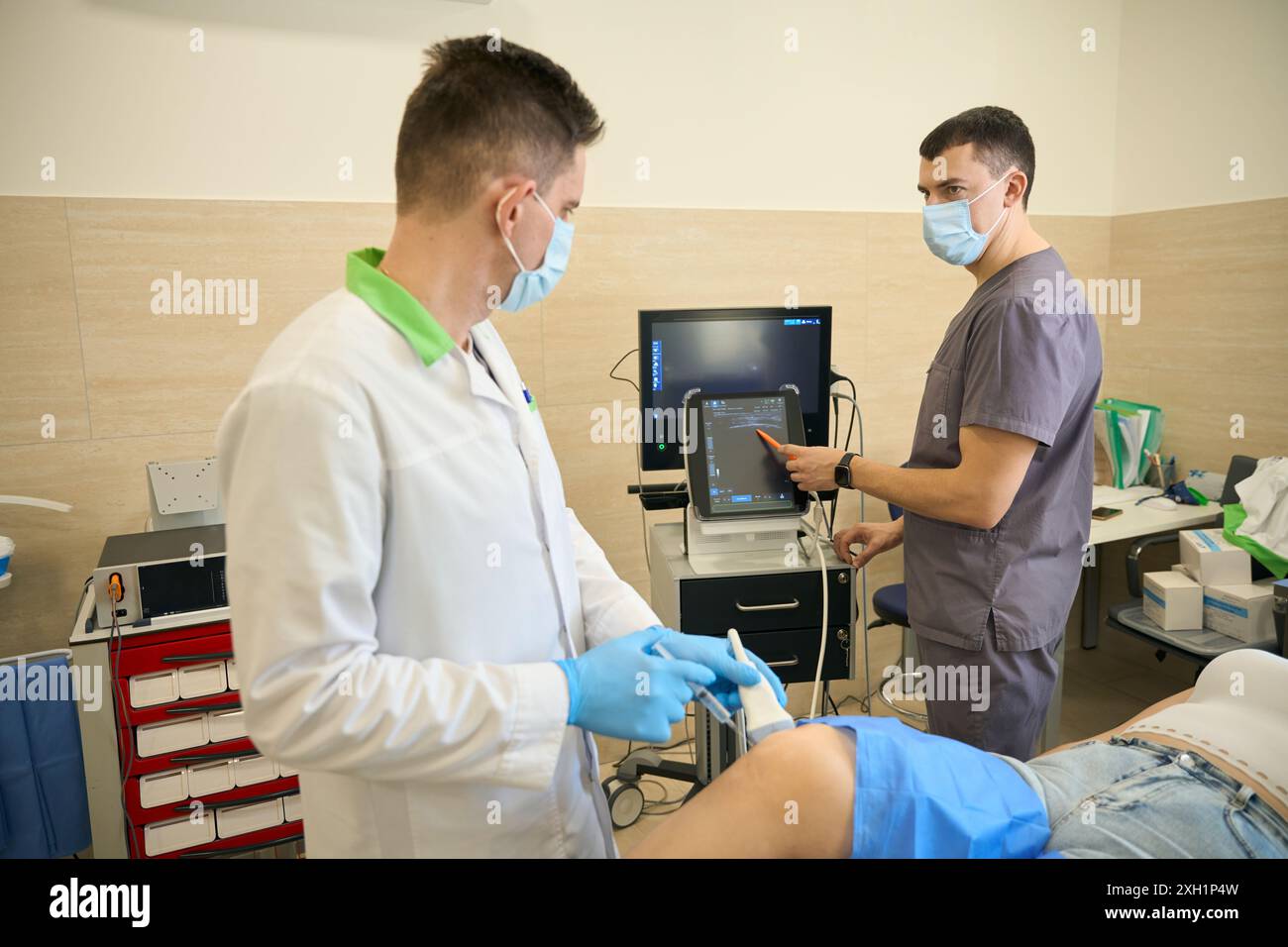 Team healthcare professionals performing ultrasound-guided knee ...