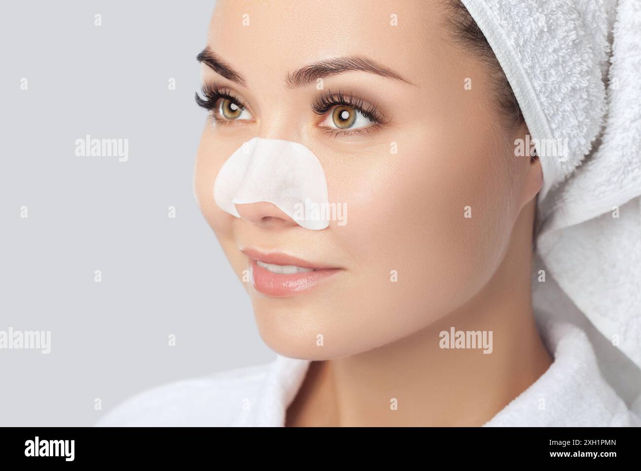 Portrait of a beautiful woman with clean skin after shower, with nose ...