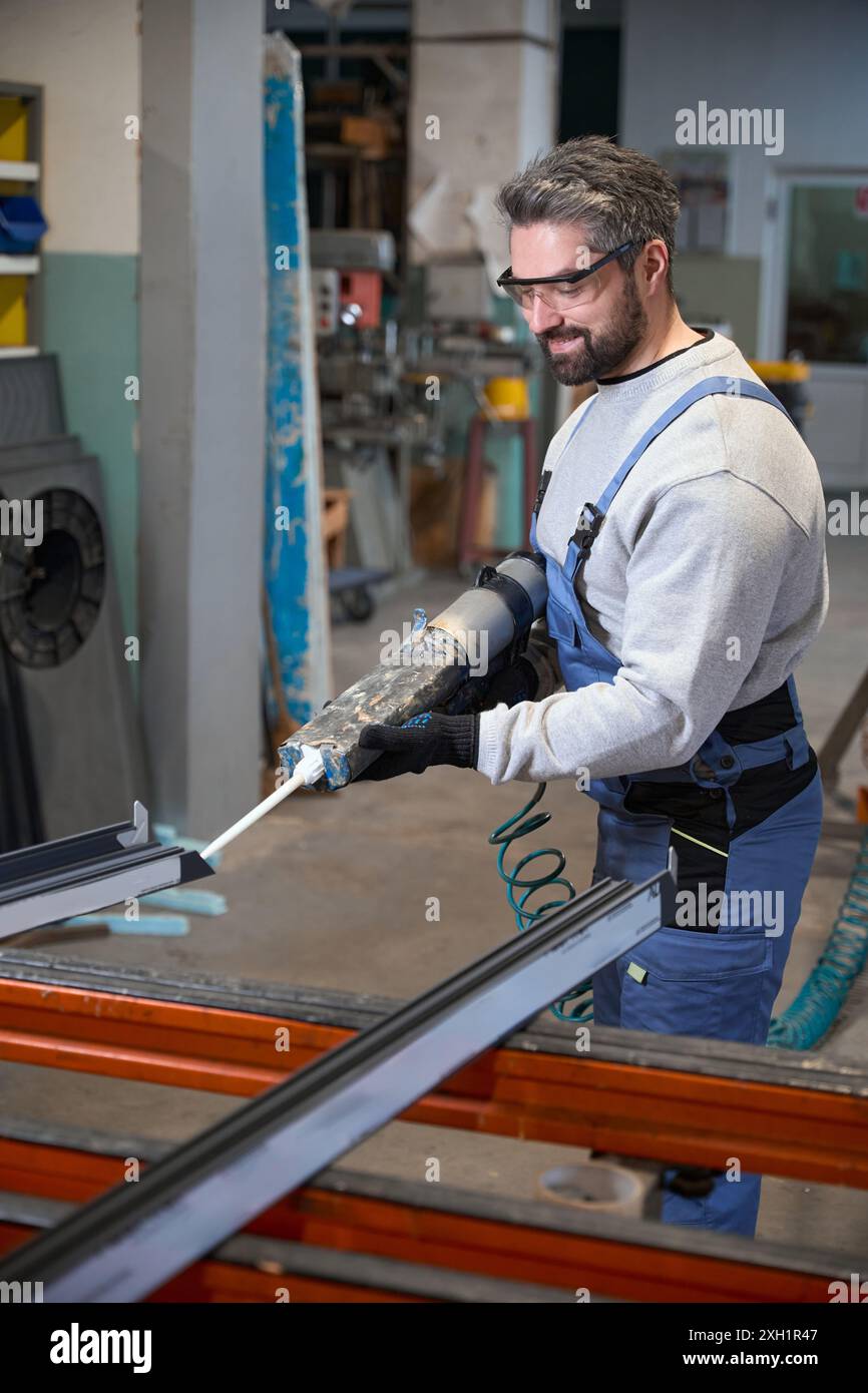 Worker works with an aluminum profile in a production workshop Stock ...