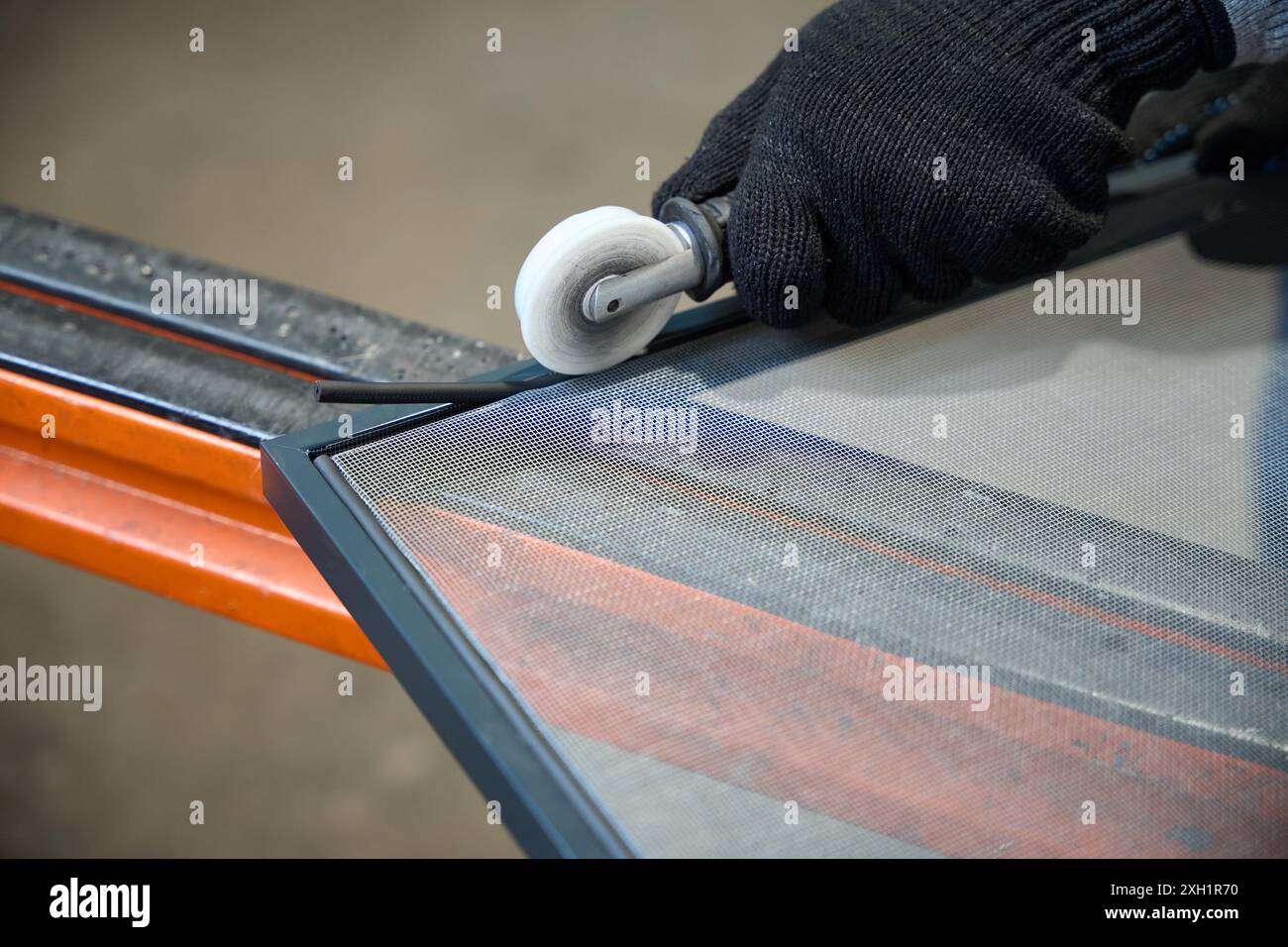 Specialist makes a frame with a mosquito net Stock Photo - Alamy