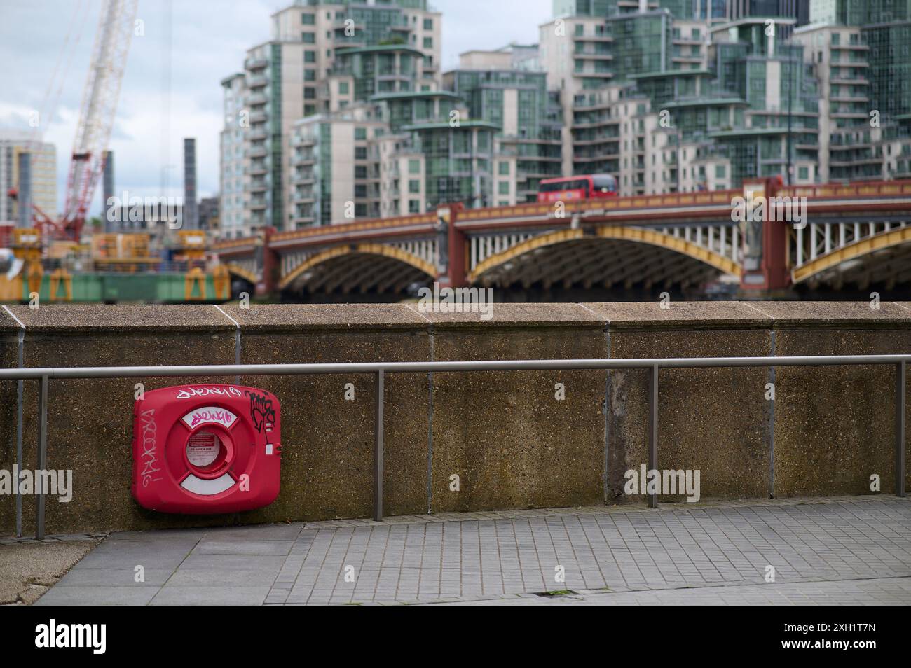 10 jul 2024 - london uk : Life ring on a concrete wall with bridge and ...