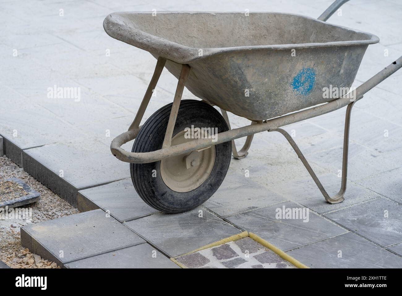 A blue wheelbarrow and cement in construction site Stock Photo - Alamy