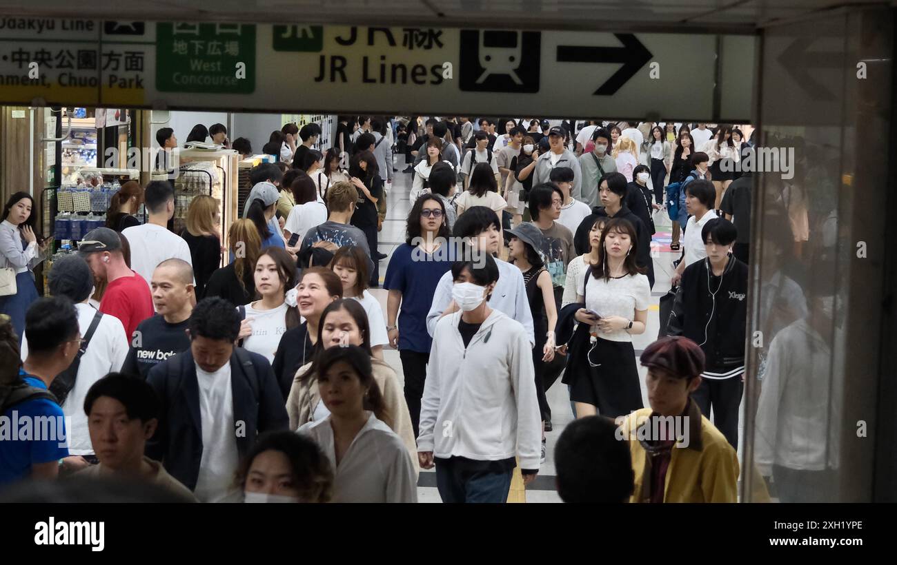 Tokyo, May 4 2024: crowded people walk through the subway of Shinjuku ...
