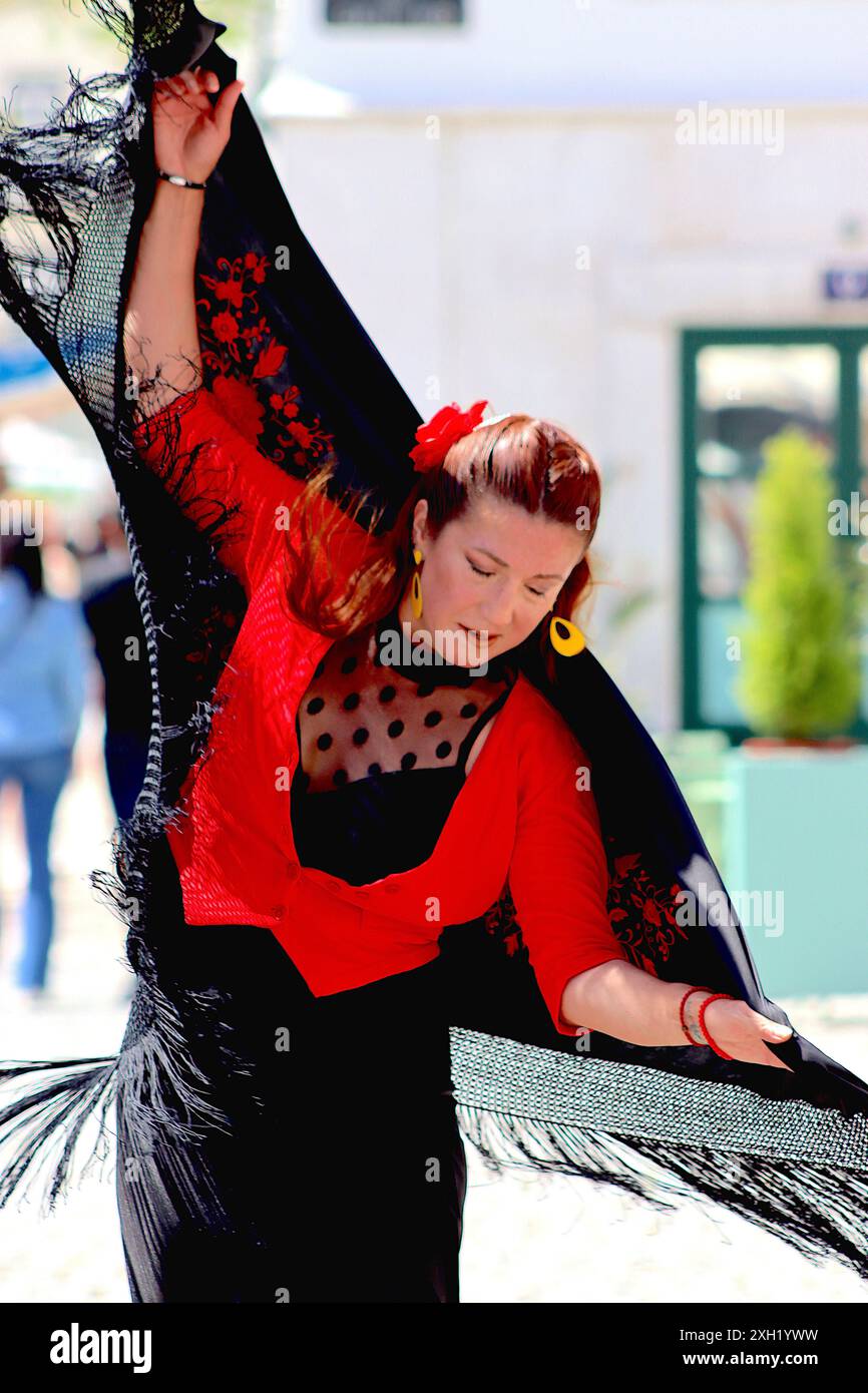 Under midday heat in a Lisbon tourist area, street performer Gloria ...