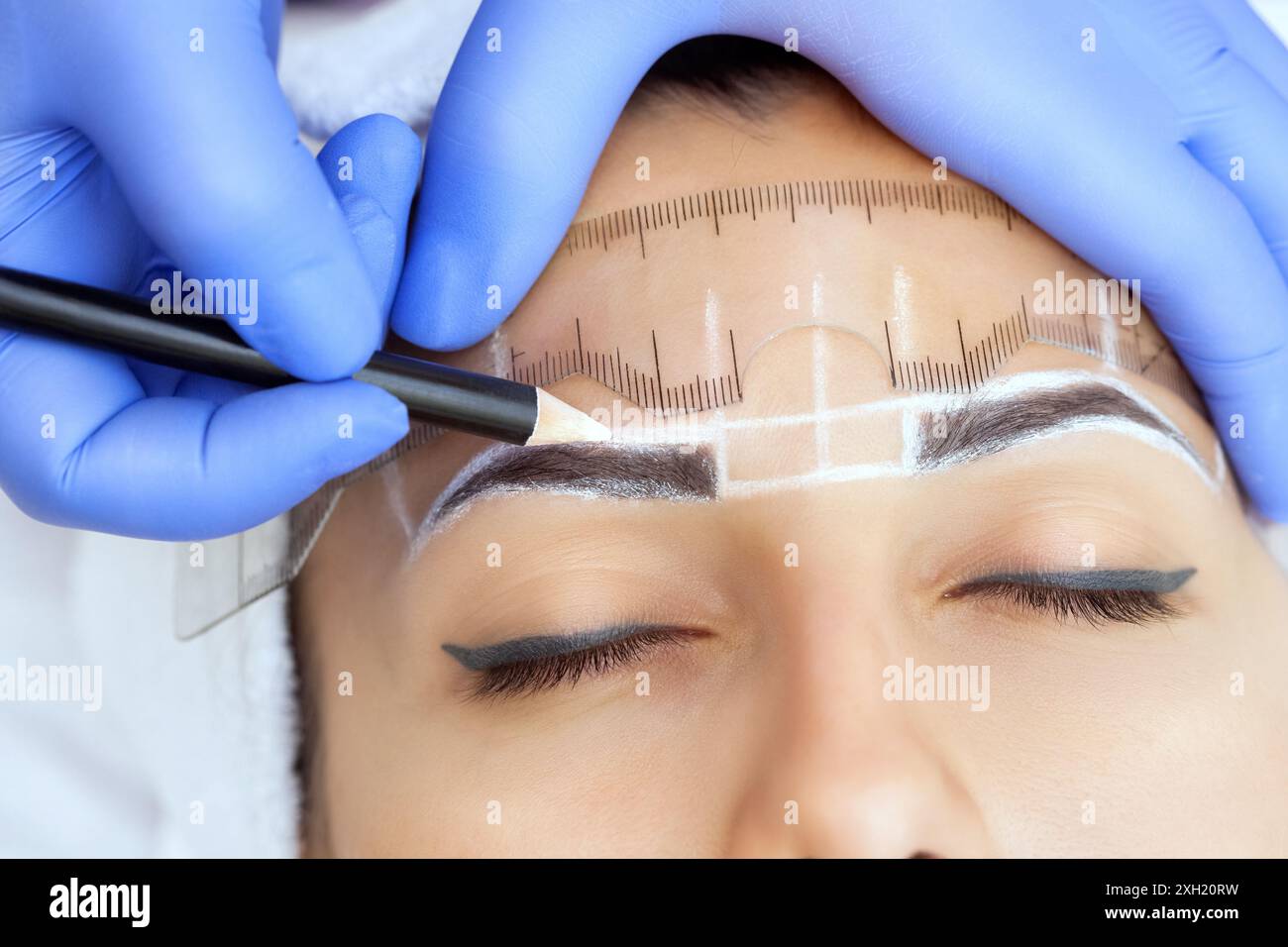 Permanent make-up for eyebrows of beautiful woman with thick brows in ...