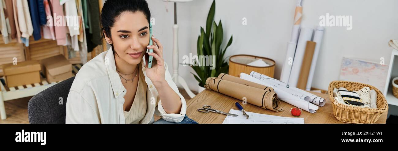 A stylish woman in casual attire upcycling clothes, talking on a cell ...