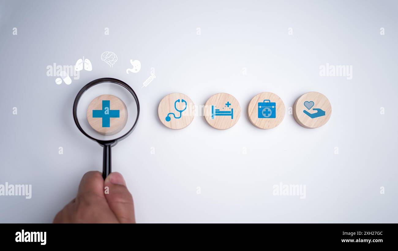 Human hands hold a magnifying glass and focus on the plus sign and ...