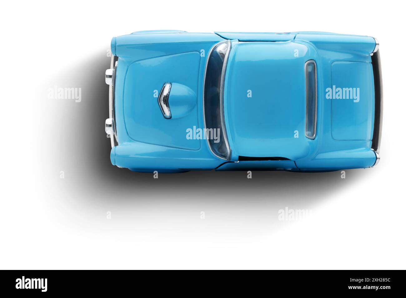 A top view of a blue toy car photographed on a white background. The ...