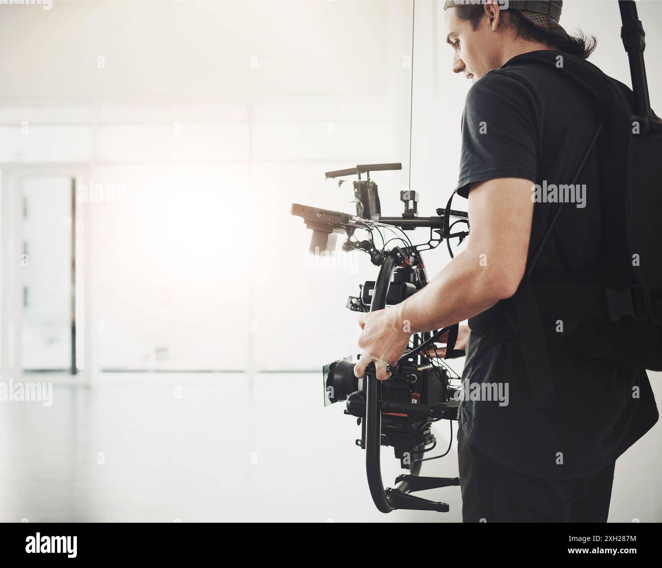 Photographer, camera and filming with stabilizing equipment on set for ...