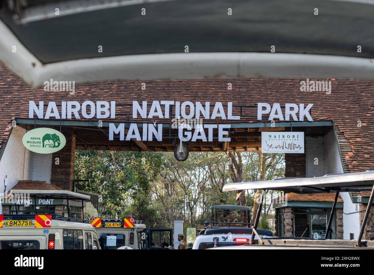 Nairobi, Kenya - March 18, 2023: Land Cruisers and safari vans wait to enter the main gate of ...