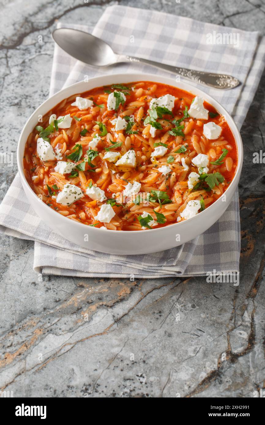 Greek pasta kritharaki or orzo with tomato sauce, feta, onion and herbs ...