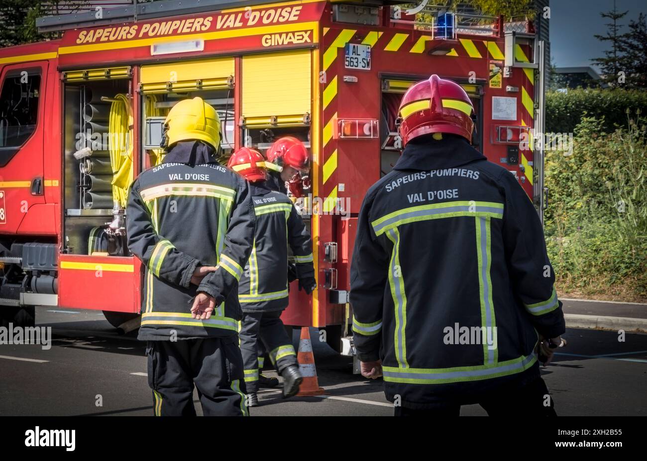Val D'Oise France. Firefighters damping down potential dry grass ...