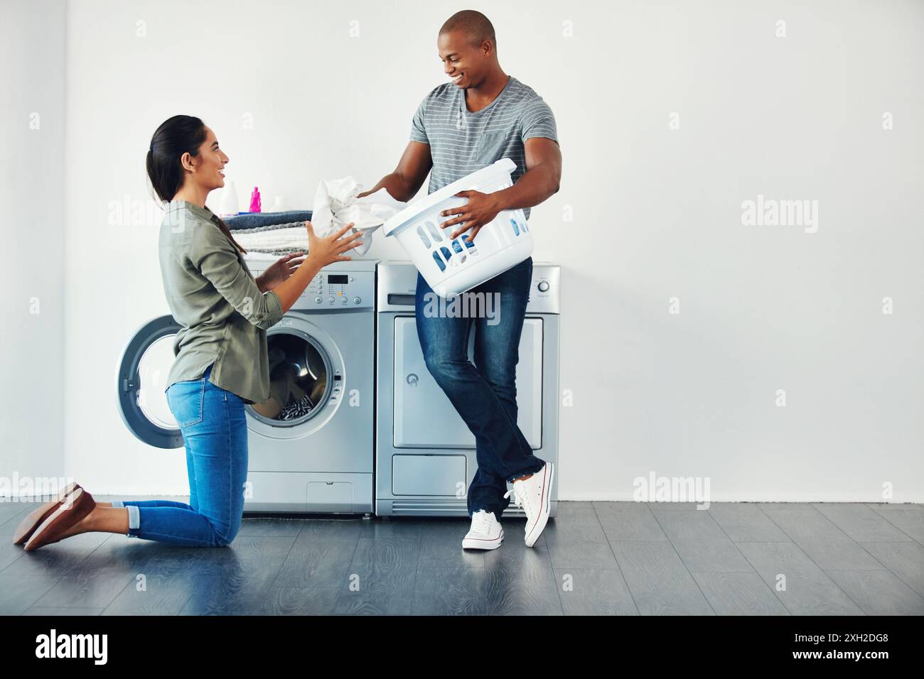 Happy couple, help and laundry in home for cleaning, hygiene and ...