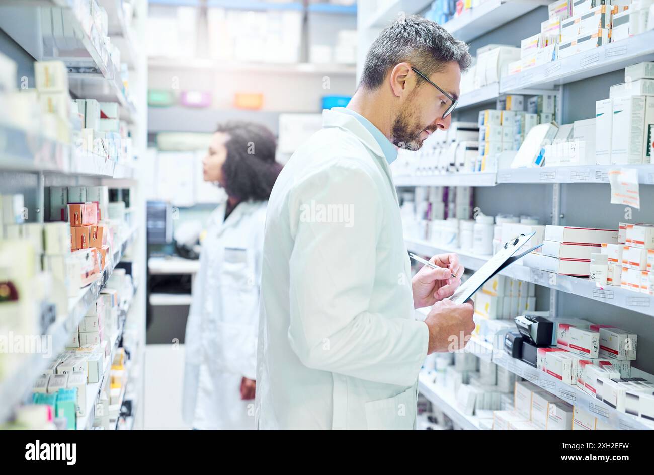 Pharmacist, drugs and man with checklist in pharmacy for dispensary ...