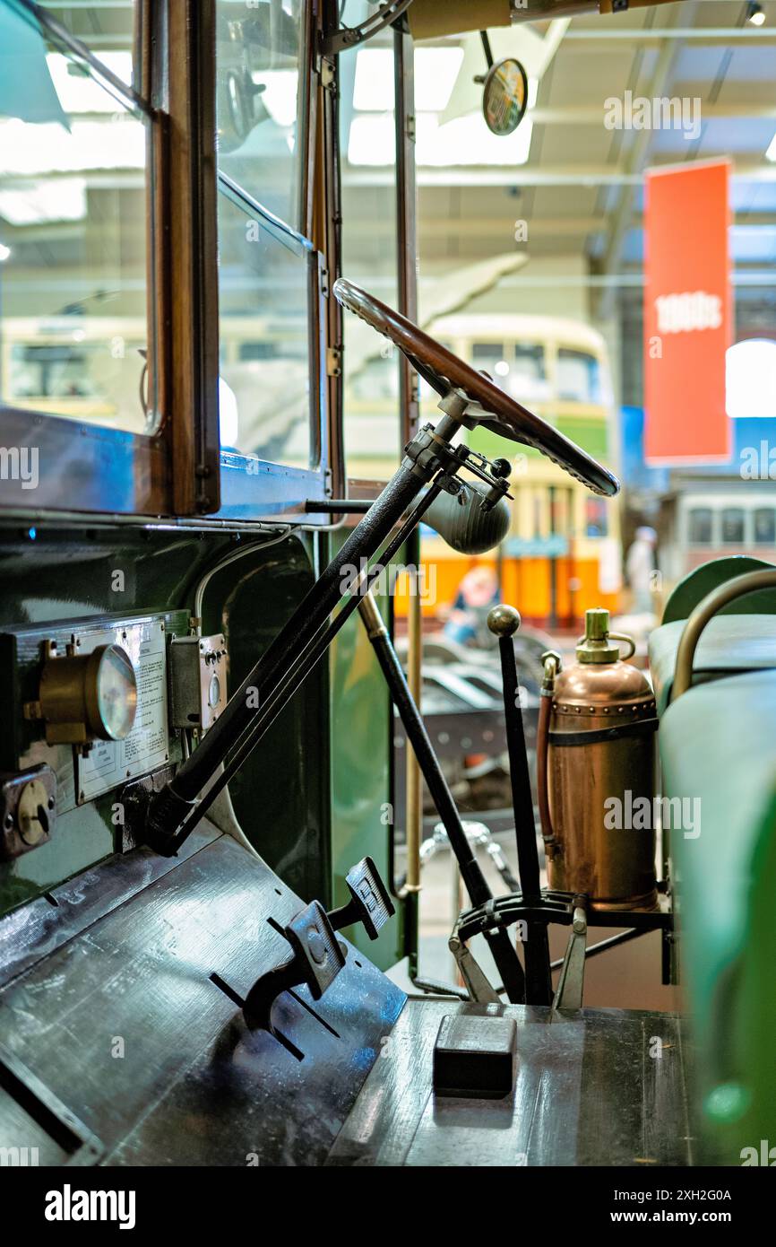 Vintage bus interior showcasing the driver's seat, steering wheel, and ...