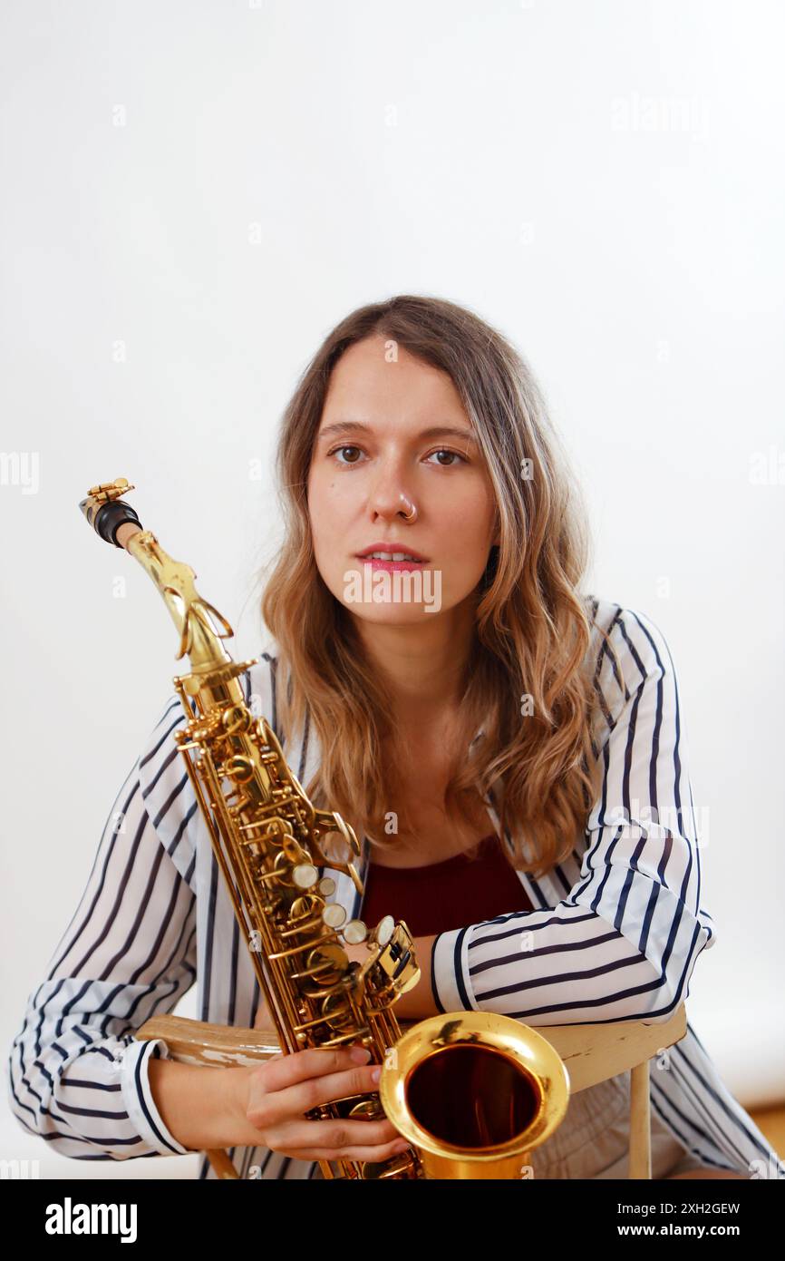 portrait of girl with saxophone on white background Stock Photo - Alamy