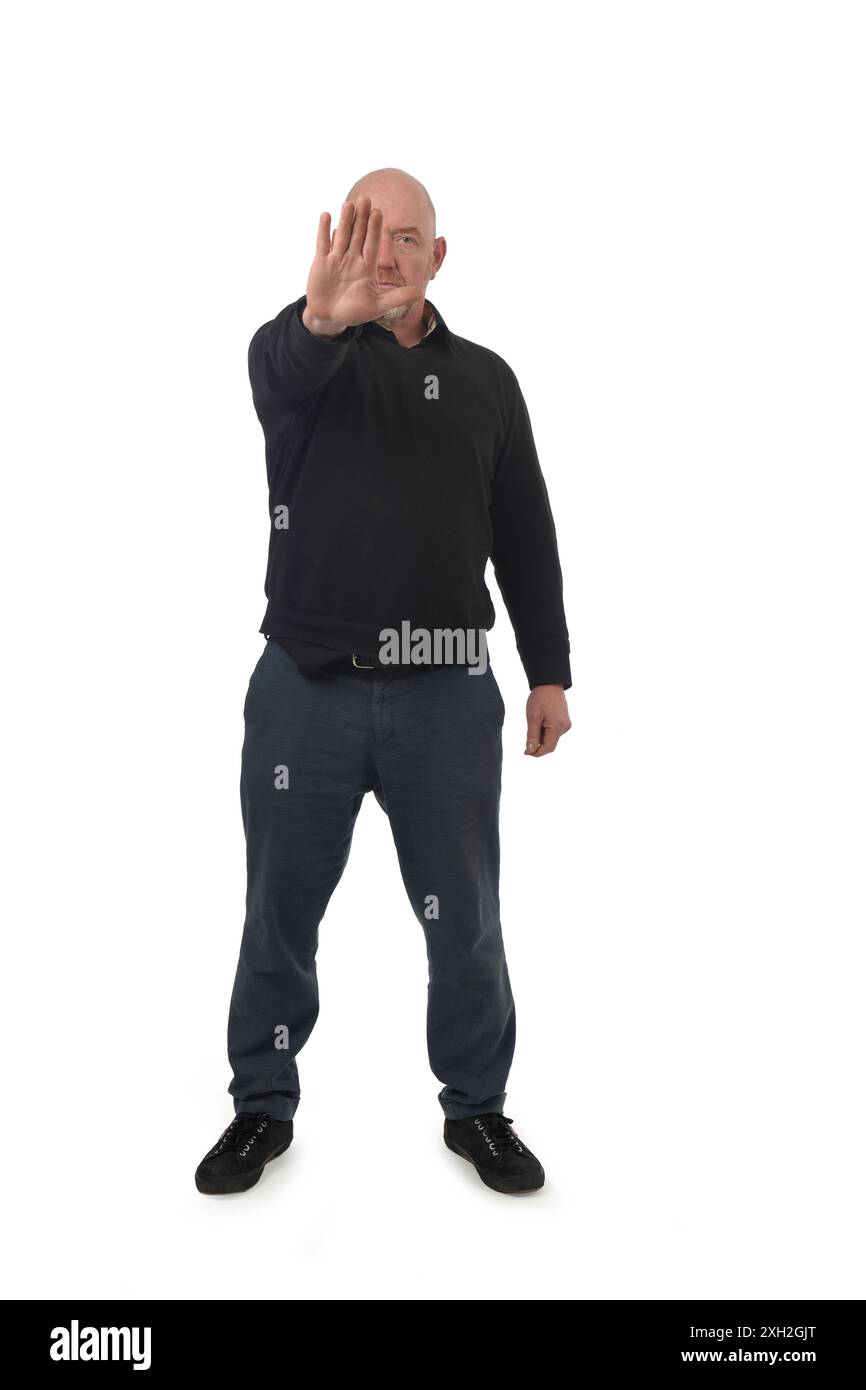 front view of a man showing the stop sign with their hands on white ...