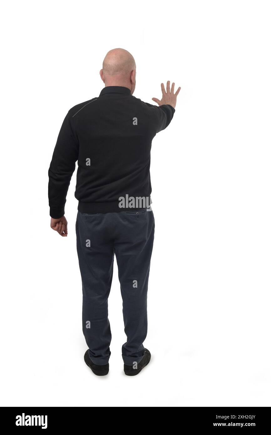 back view of a man showing the stop sign with their hands on white ...