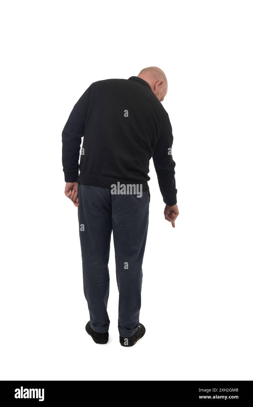 back view of a man pointing finger at the ground isolated on white ...