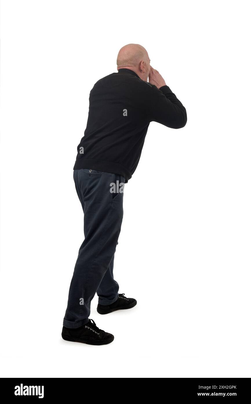 side,rear view of a standing man who is screaming on white background ...